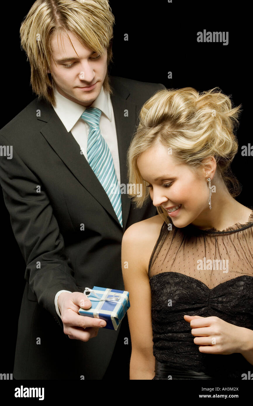 Man offering a gift to woman Stock Photo - Alamy