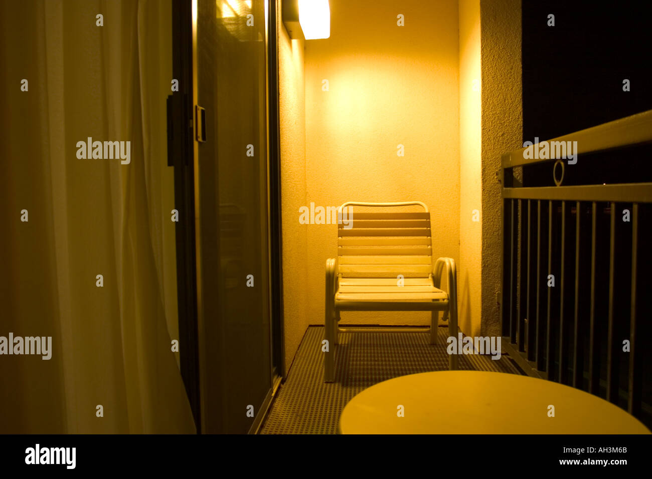 Chair on the outside porch of a hotel room at night Stock Photo - Alamy