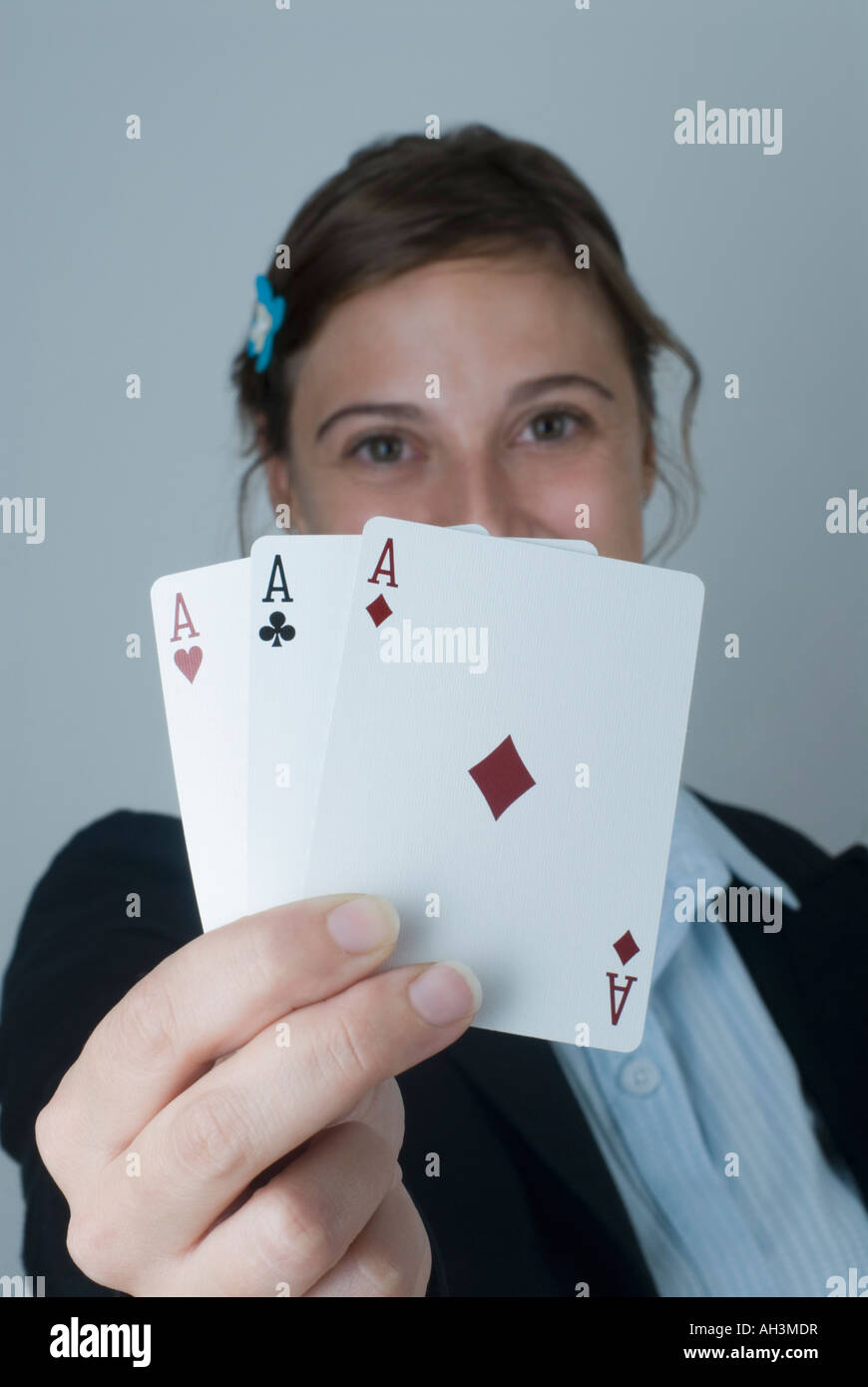 Portrait of a young woman holding playing cards Stock Photo - Alamy