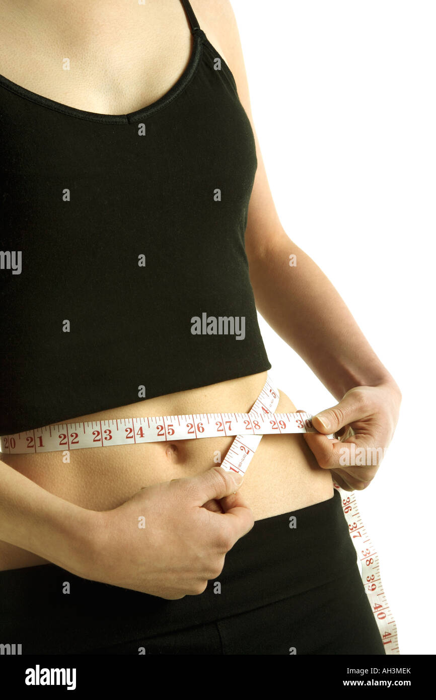 Woman measuring her waist Stock Photo - Alamy Woman measuring her waist Stock Photo - Alamy