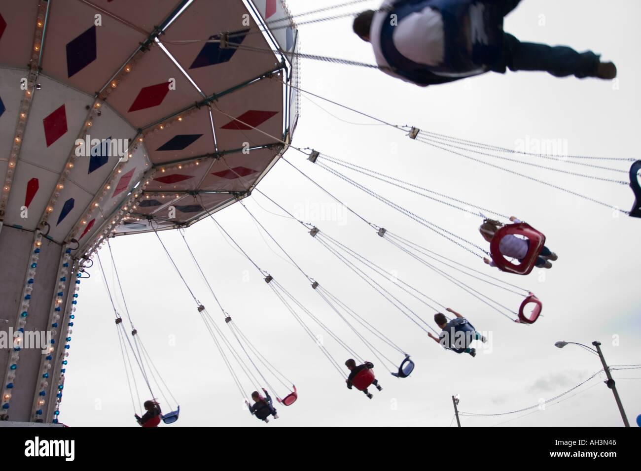 People at a carnival at a fair on a swing ride Stock Photo - Alamy