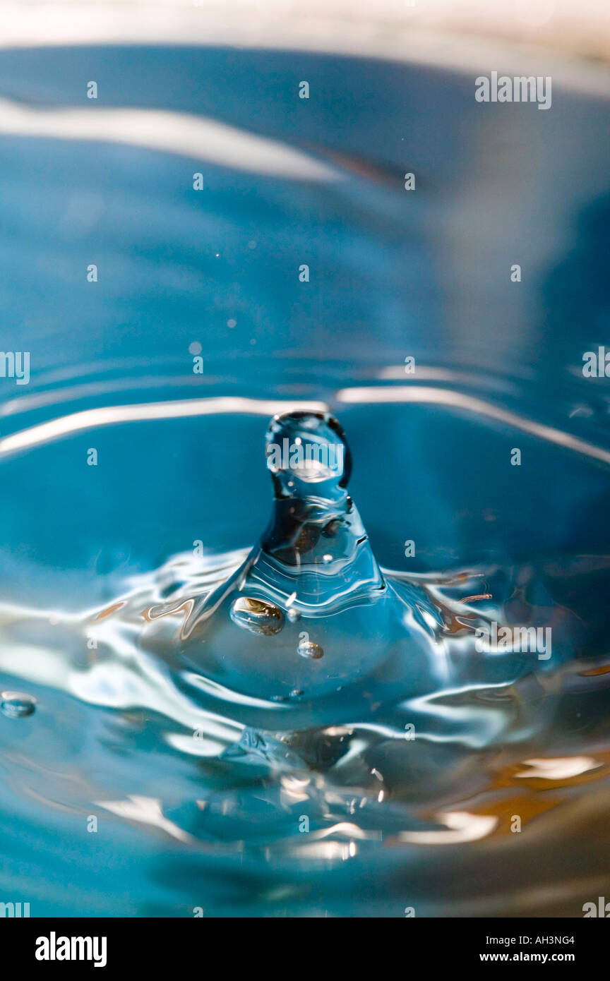a water droplet hitting a water surface and splashing Stock Photo - Alamy