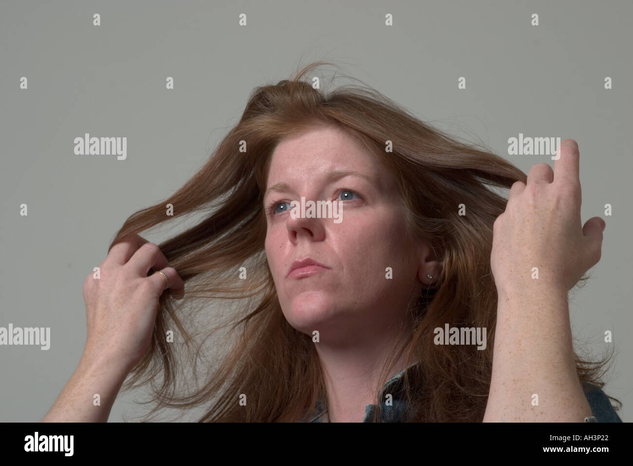 Woman running hands through hair hi-res stock photography and images ...