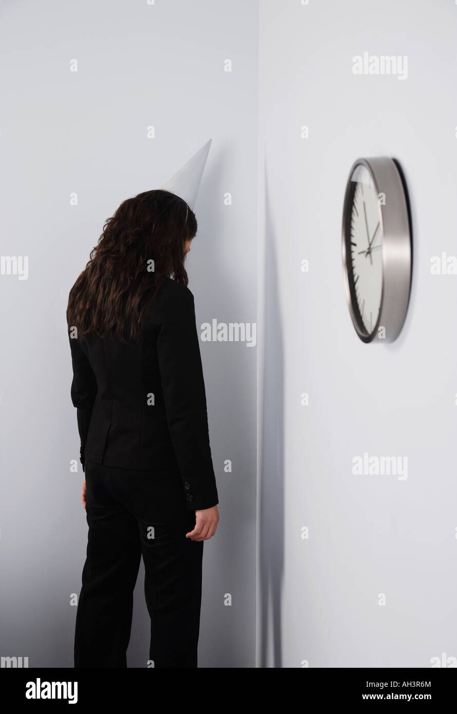 Businesswoman facing corner Stock Photo - Alamy