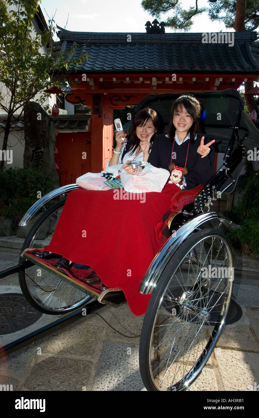 rickshaw driver and customers outside temple Kyoto city Honshu Japan ...