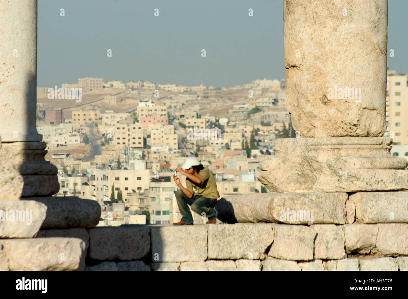 tourist taking photos at the Citadel ruins Jebel al Qal ah Amman Jordan ...