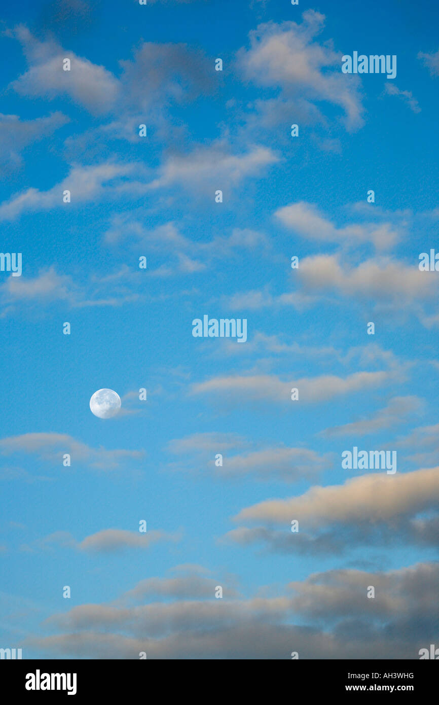 Moon and clouds in a blue sky Stock Photo - Alamy