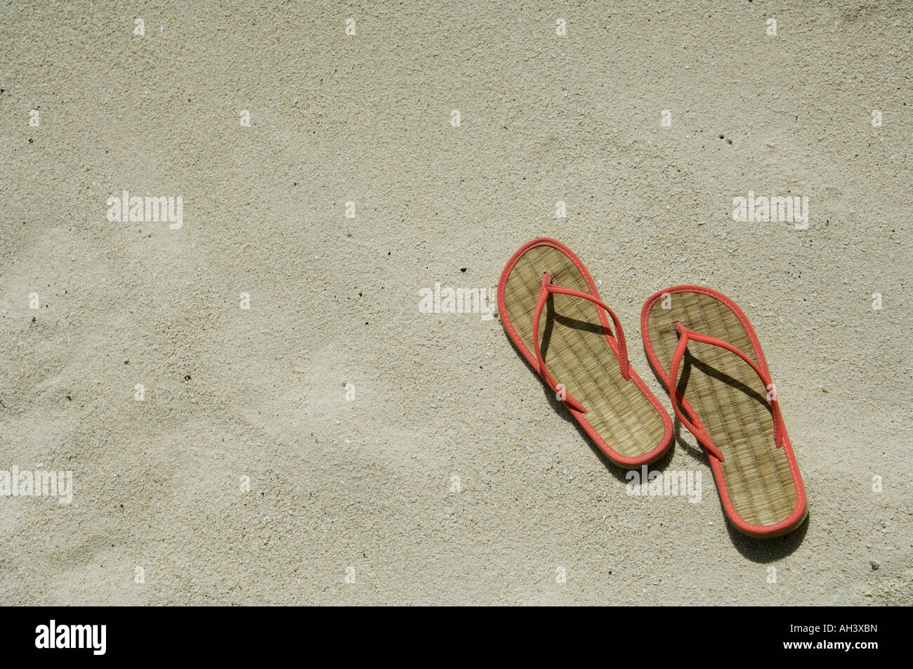 A pair of slippers on sand Stock Photo - Alamy