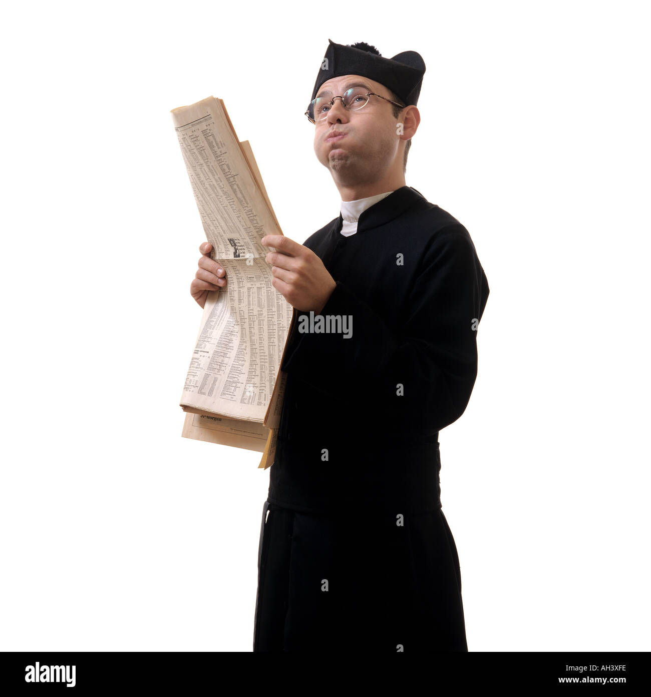 CATHOLIC PRIEST WITH A FINANCIAL NEWSPAPER AND LOOKING UPWARD Stock ...