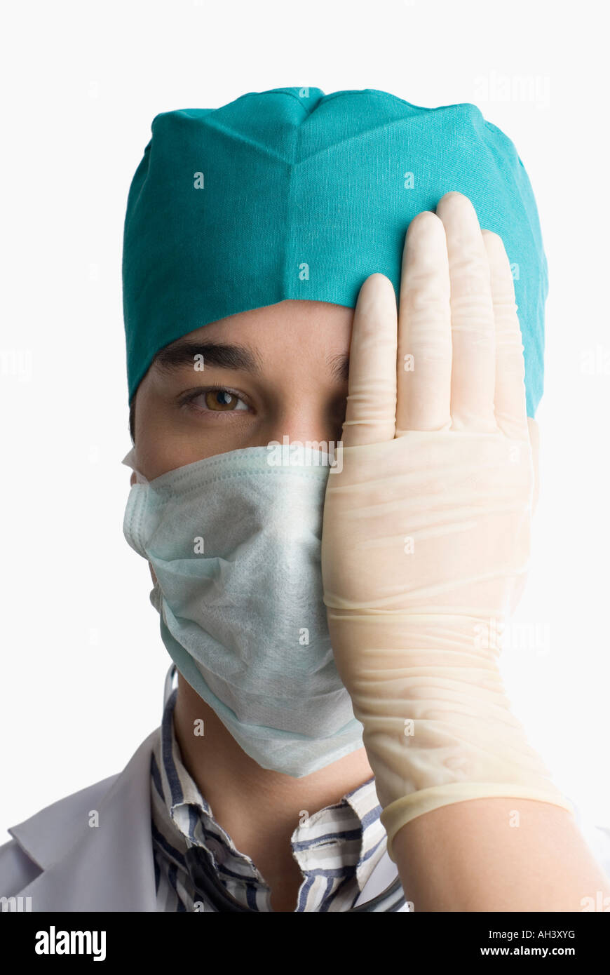 Portrait of a male doctor covering his eye with her hand Stock Photo ...