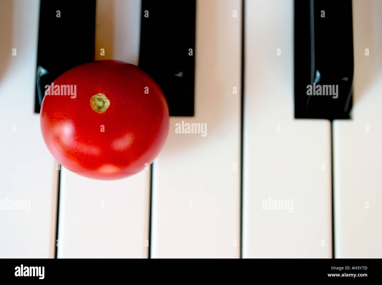 Piano keyboard close up with tomato Stock Photo - Alamy