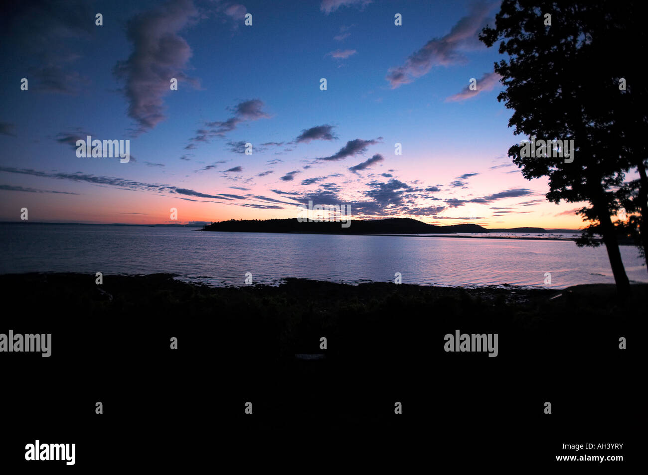 Sunset at the coastline Stock Photo - Alamy