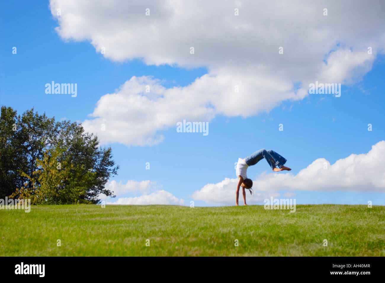 Girl doing a back flip Stock Photo - Alamy