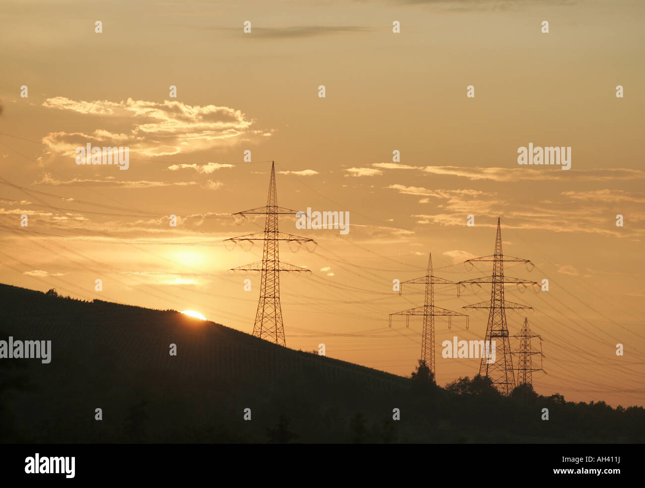Electric power lines at sunset Stock Photo - Alamy