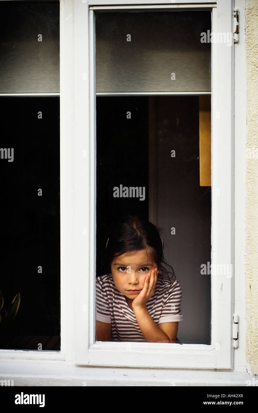 Child waits at the window Stock Photo - Alamy