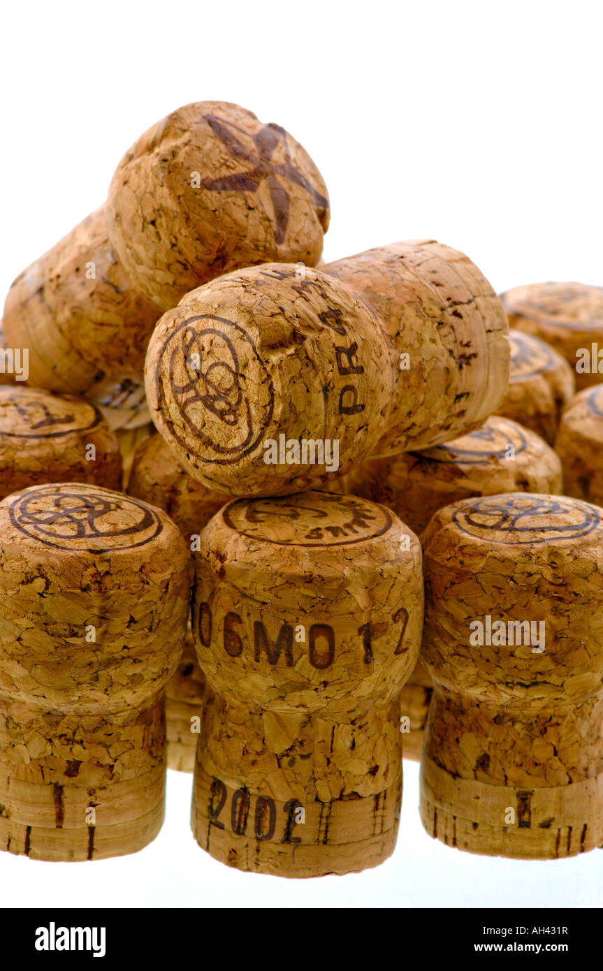 Popped champagne and sparkling wine corks in a pile, on a white ...