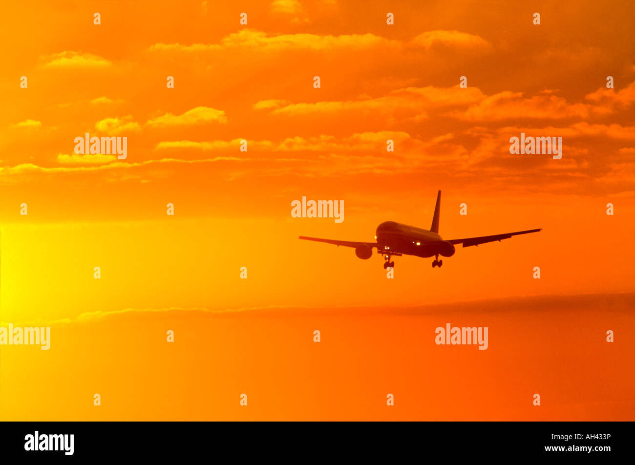 Commercial Airliner landing at Sunset Stock Photo - Alamy
