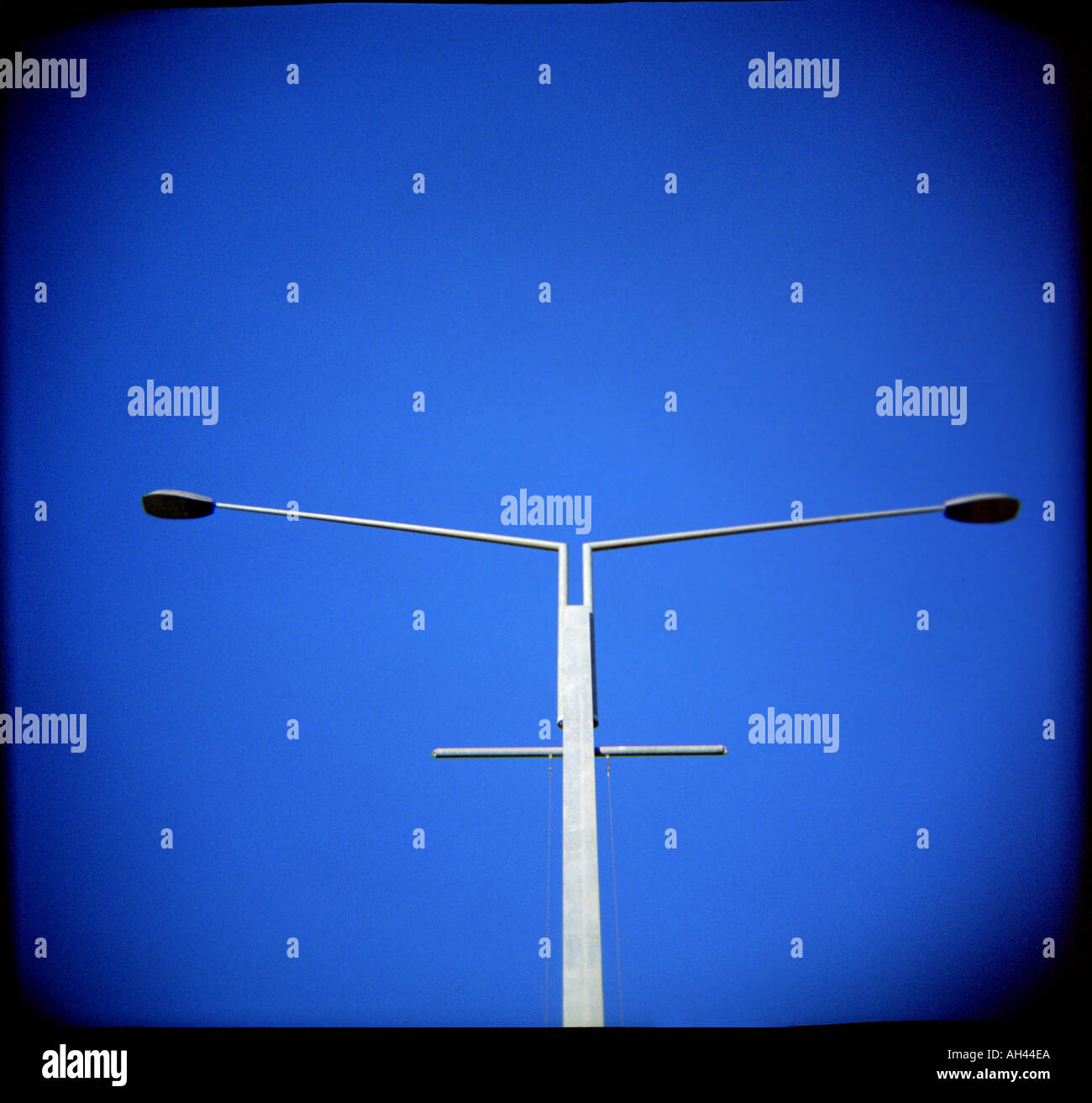 Wishbone type double street light photographed against a clear blue sky ...