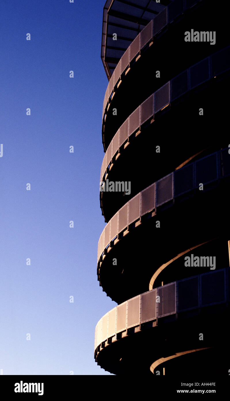 Vertical crop of a side of a round car park accesses ramp to the upper ...