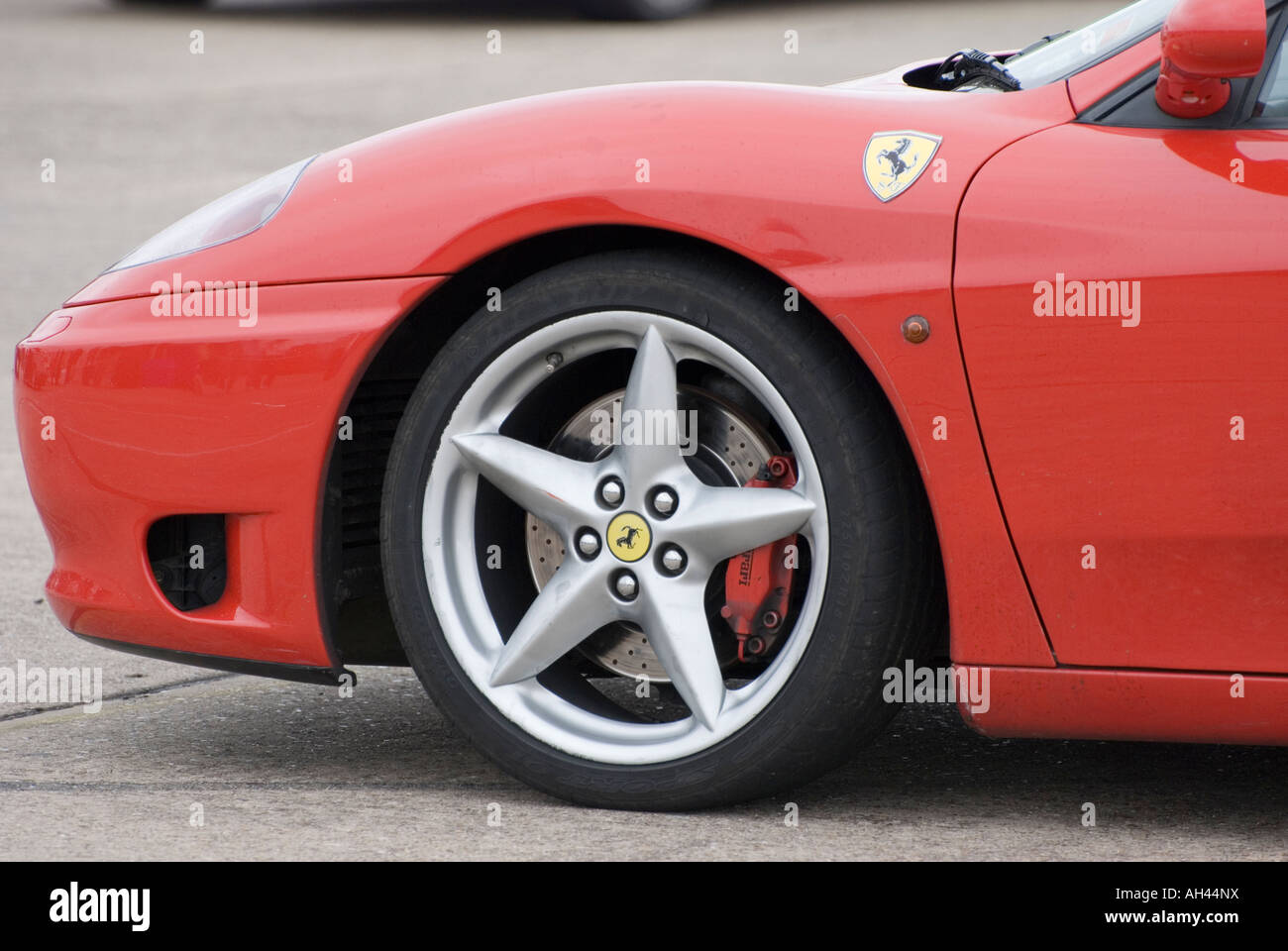 Red Ferrari with alloy spoked wheel Stock Photo - Alamy