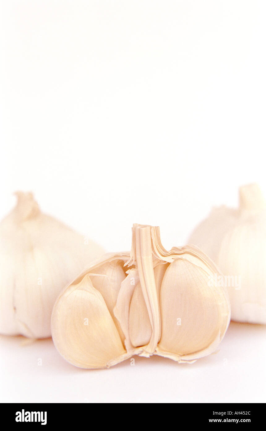 Three cloves of garlic on with background Stock Photo - Alamy