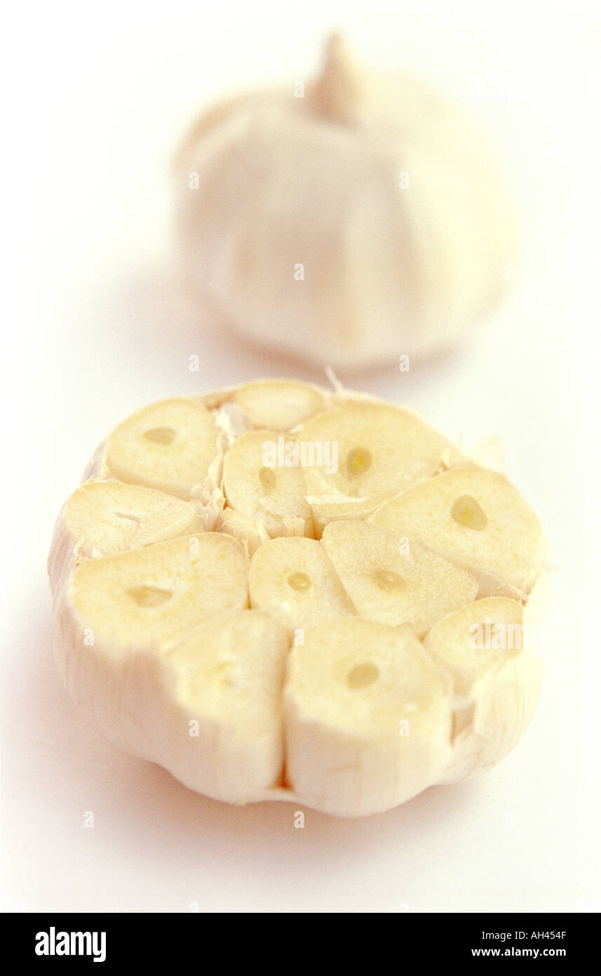A full and halved head of garlic sliced on with clean background Stock ...