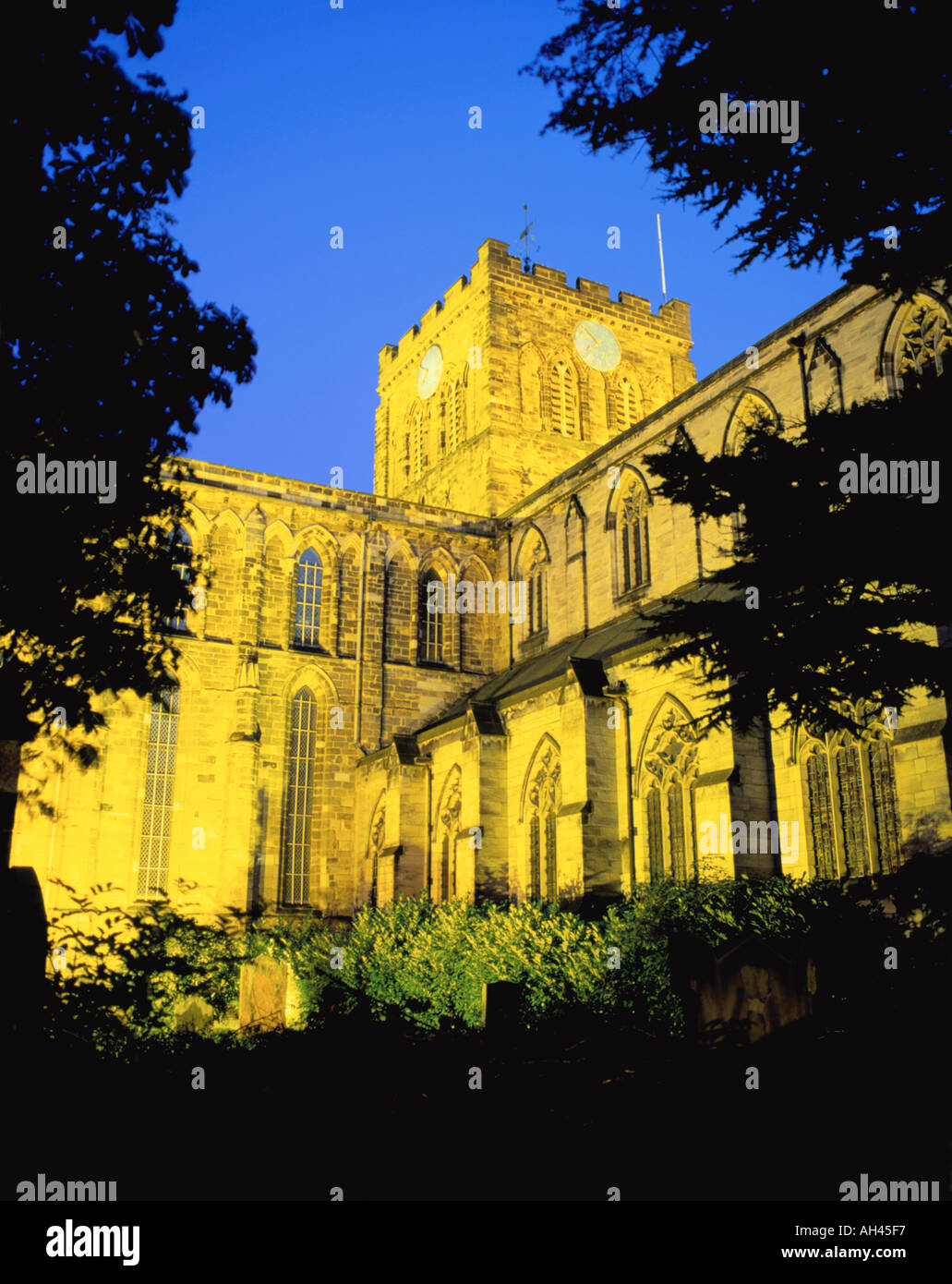 Illuminated picturesque Hexham Abbey from the north west at night ...