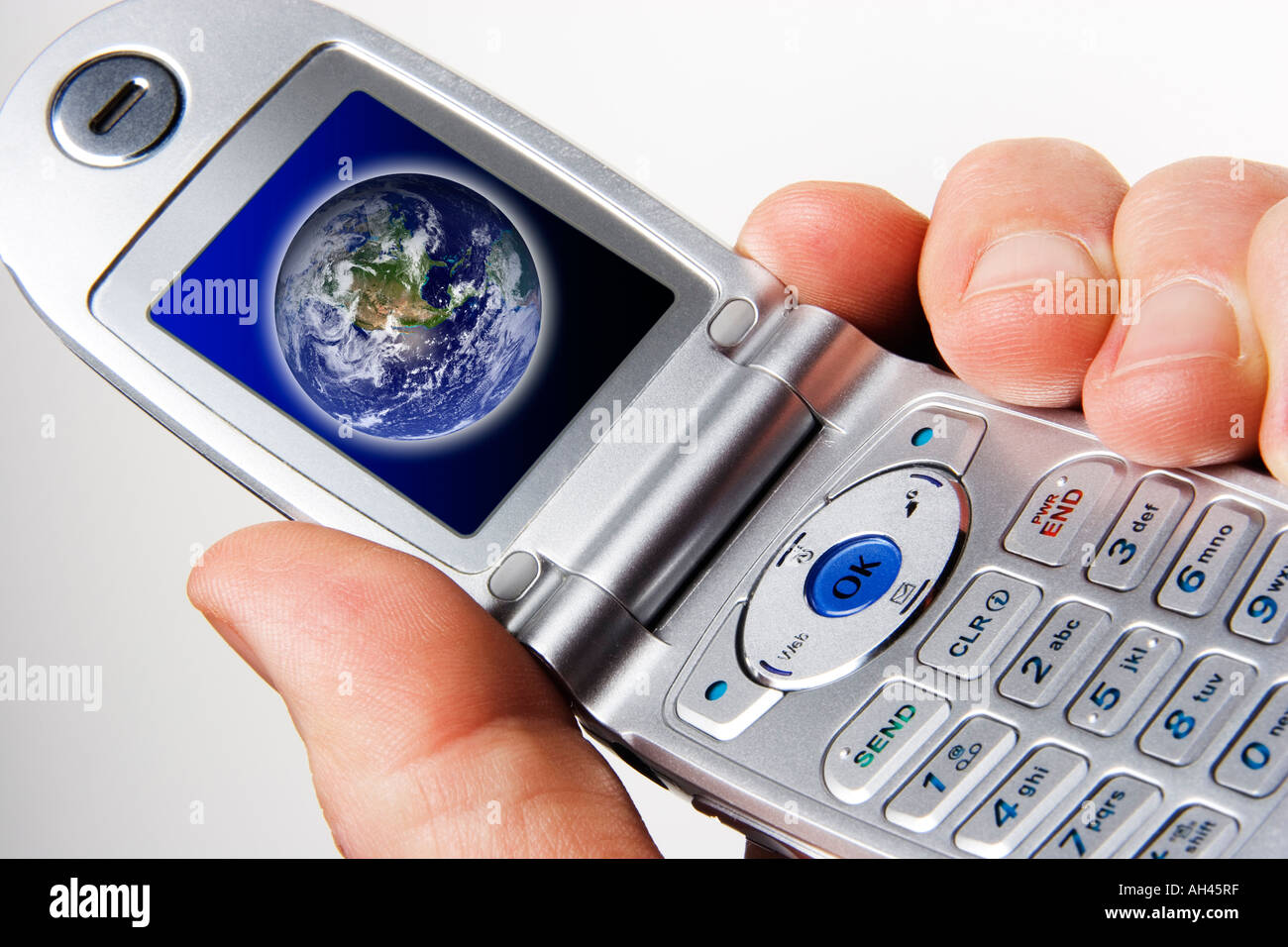 Cellular phone with an earth in the screen Stock Photo - Alamy