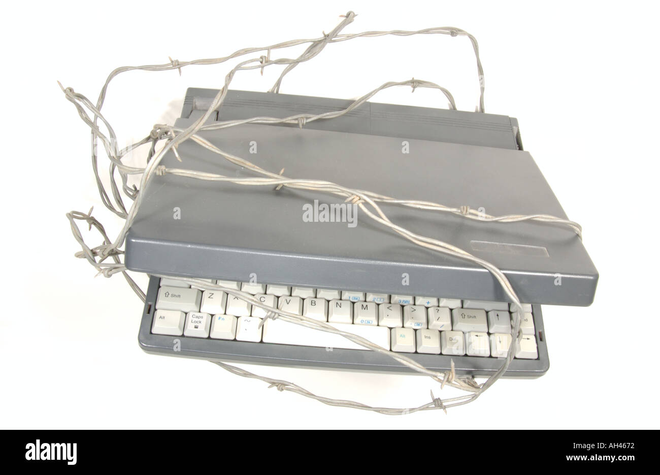 Laptop protected by barbed wire Stock Photo - Alamy