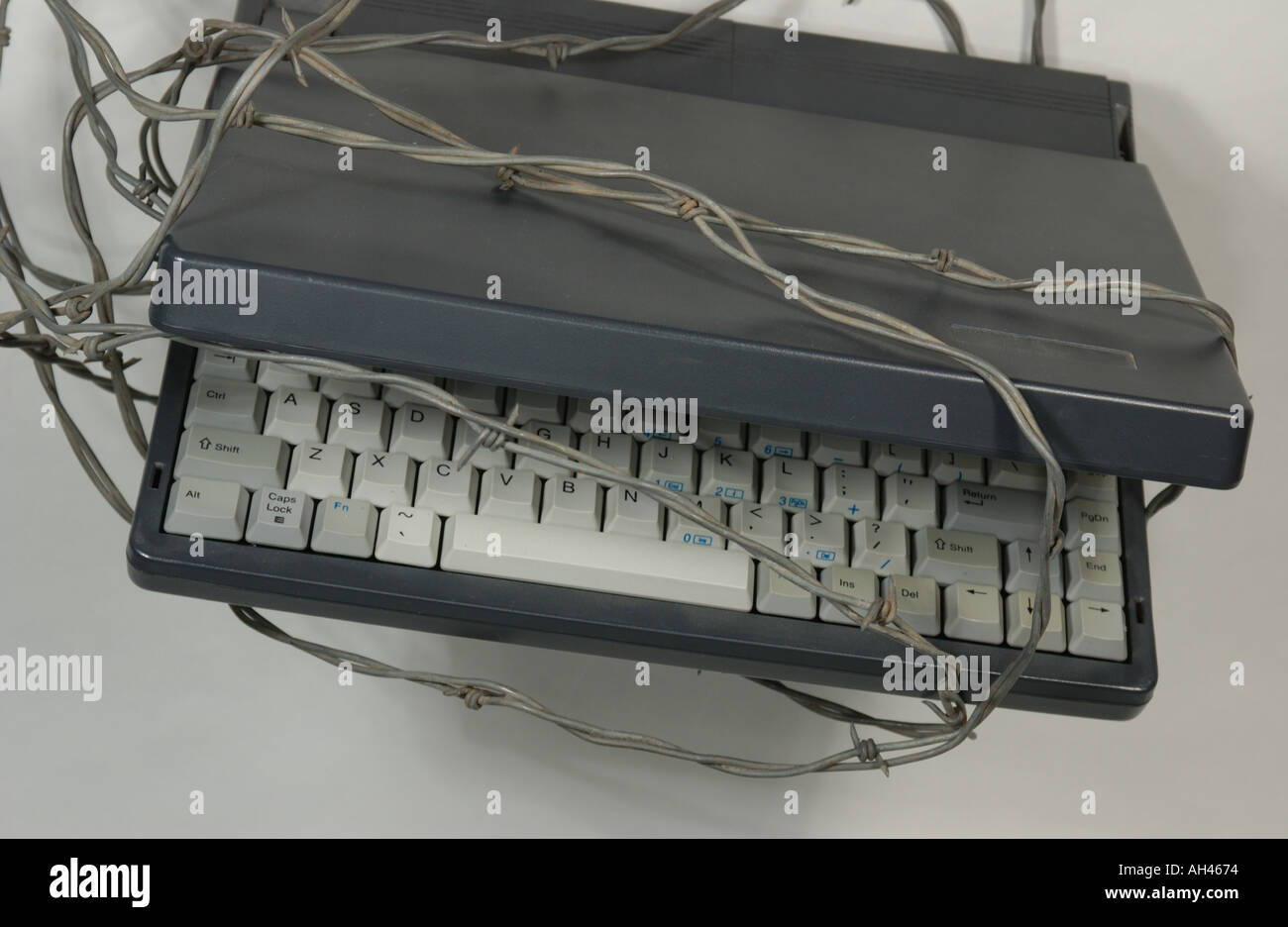 Laptop protected by barbed wire Stock Photo - Alamy