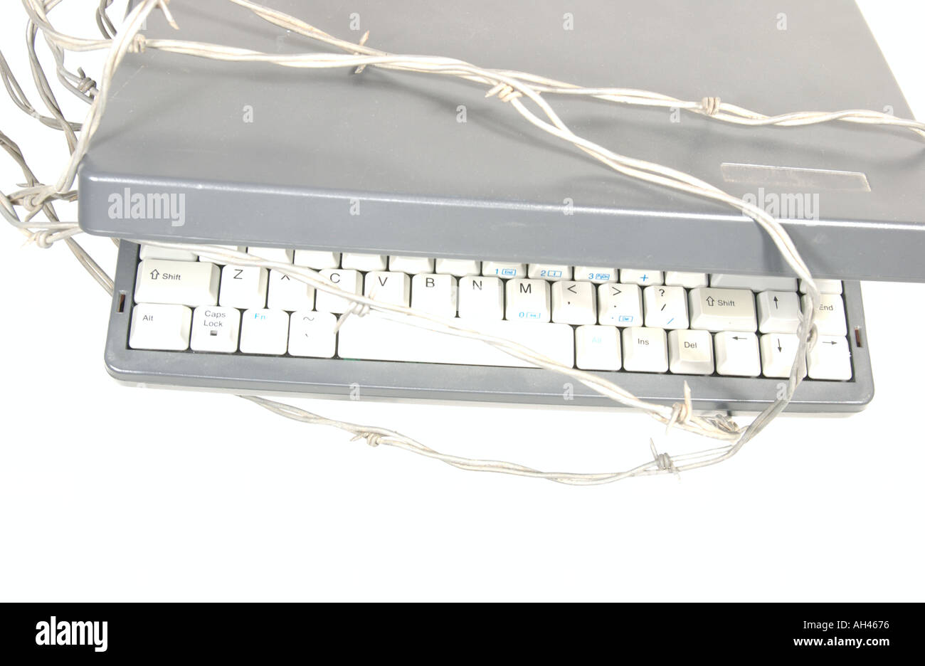 Laptop protected by barbed wire Stock Photo - Alamy
