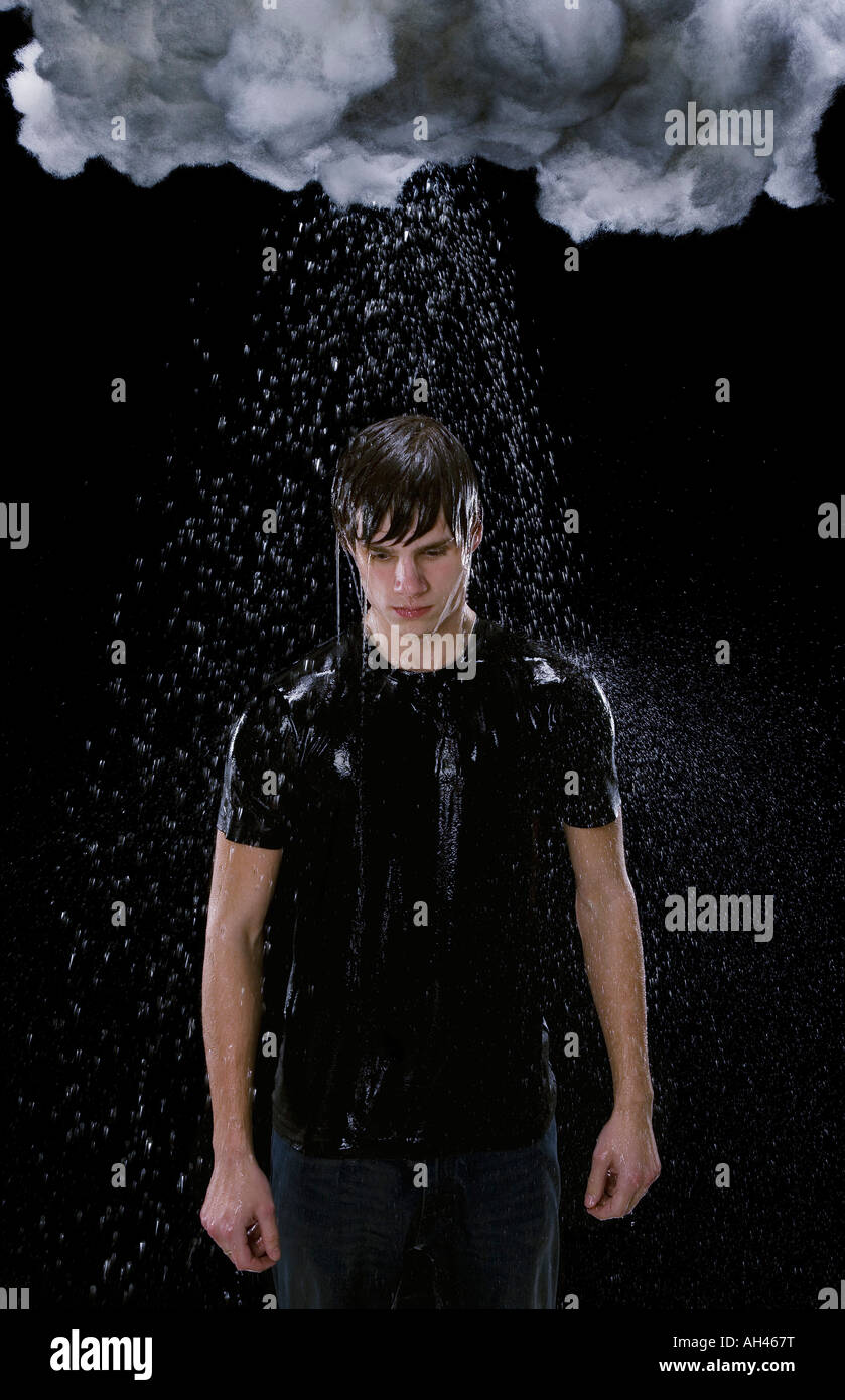 Man in rain under dark cloud Stock Photo - Alamy