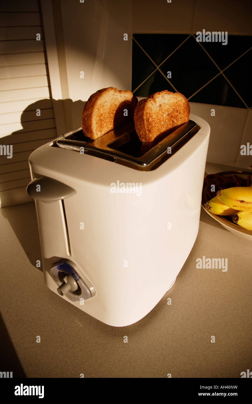 Toast in toaster Stock Photo - Alamy