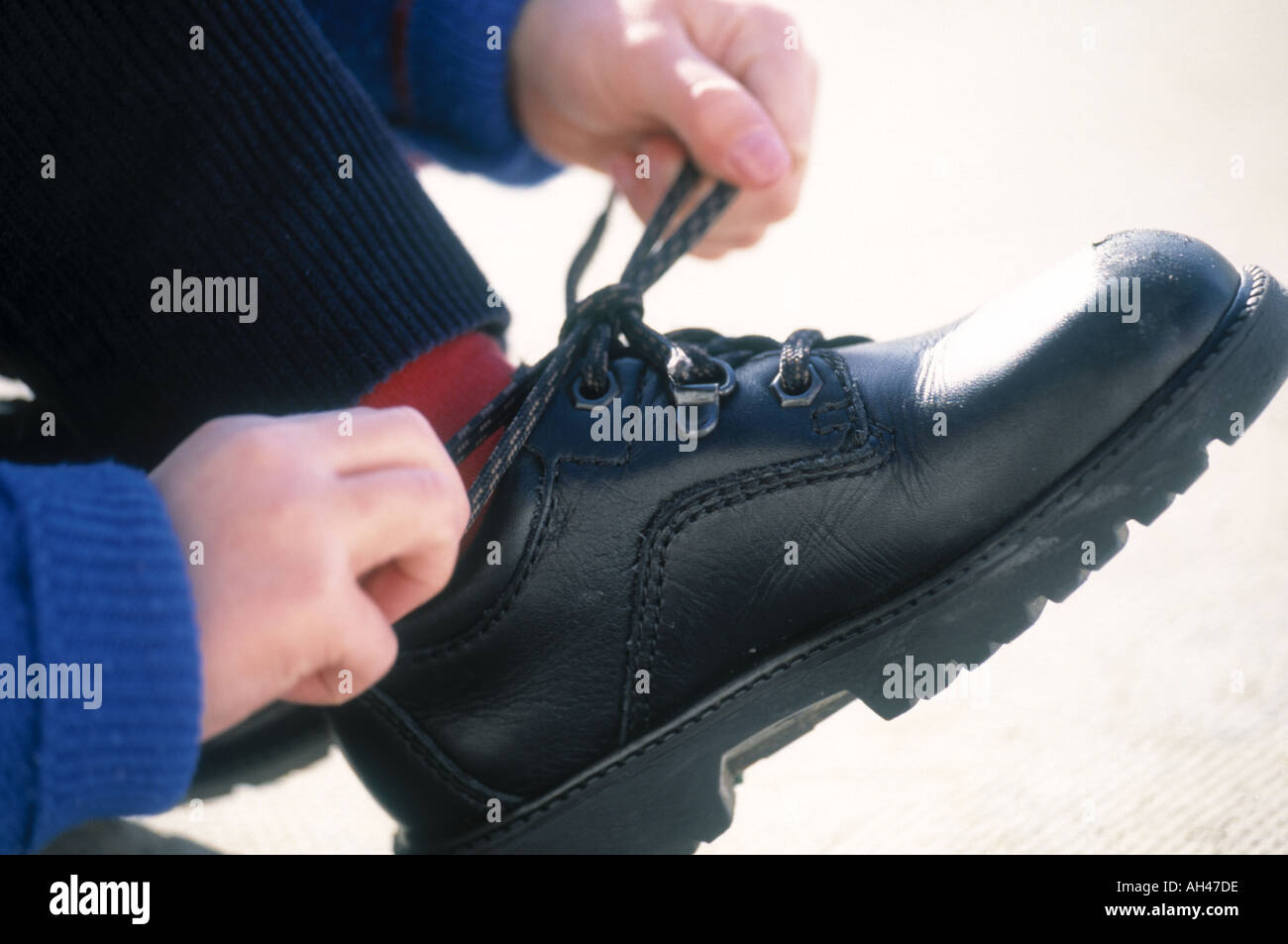 Doing up laces hi-res stock photography and images - Alamy