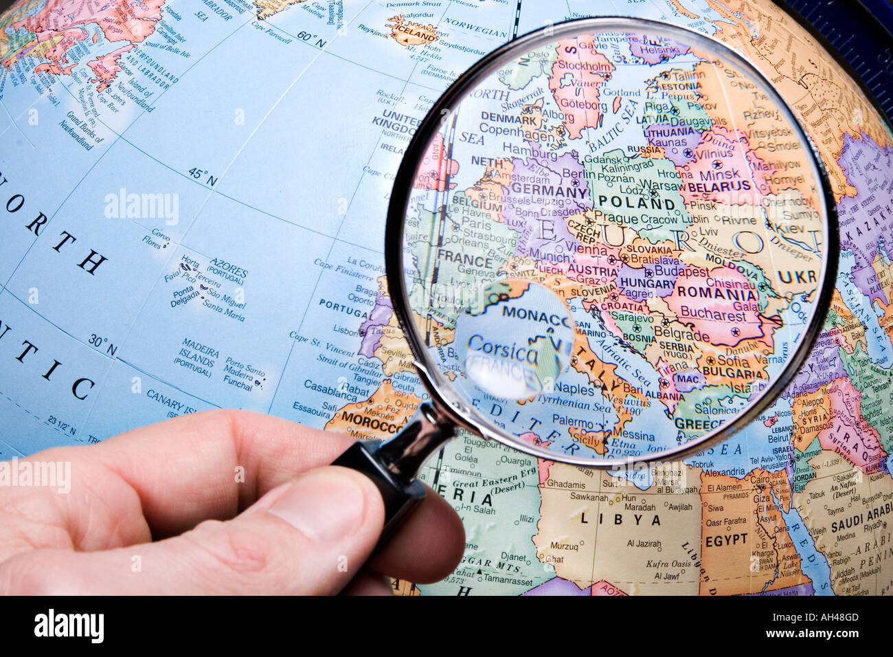 Globe and magnifying glass Stock Photo - Alamy