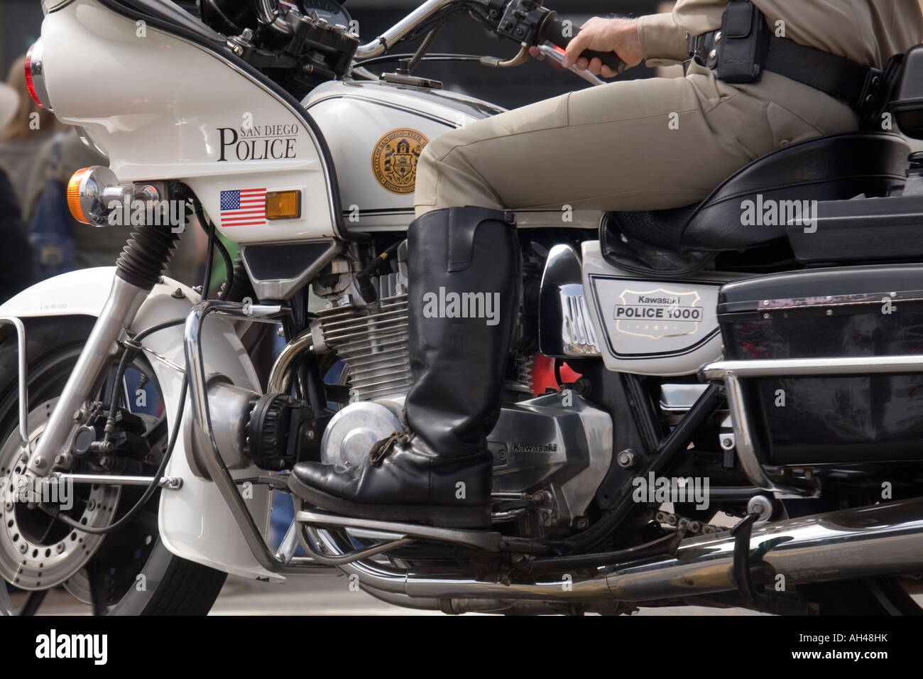 A police motorcycle photographed up close, with an officer sitting ...