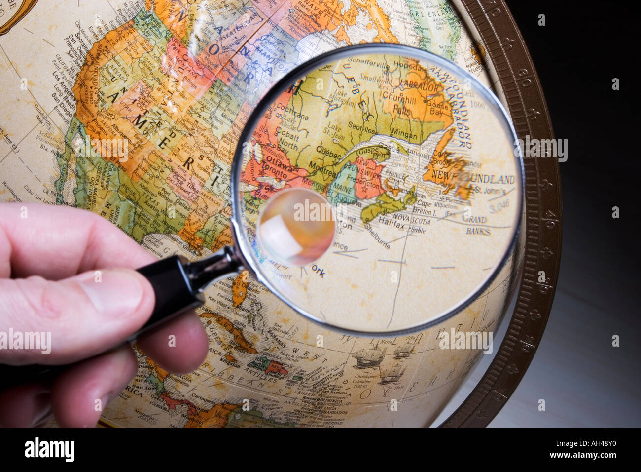 Globe and magnifying glass Stock Photo - Alamy