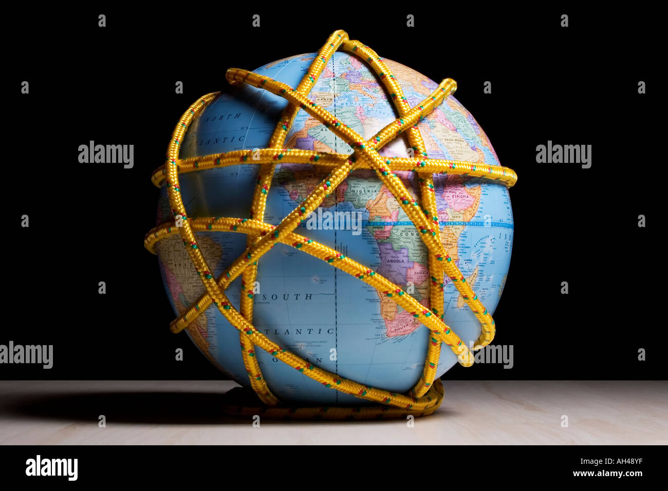 Earth globe wrapped with rope Stock Photo - Alamy