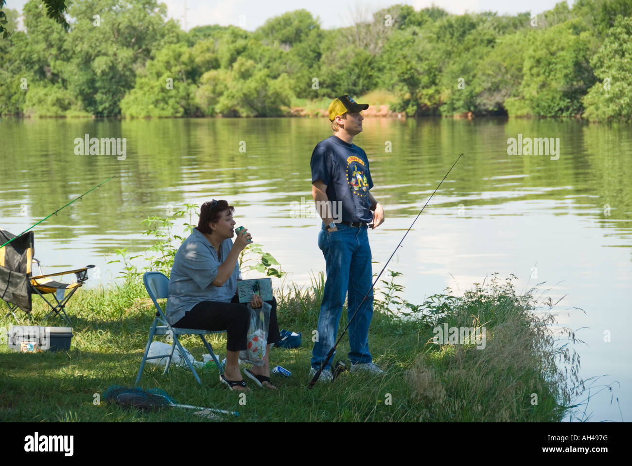 A man and woman fish in Overholser lake off the bank. Oklahoma, USA ...
