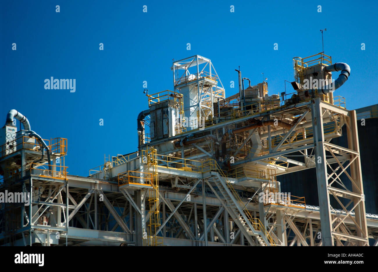Industrial plant with smokestacks and metal structures, representing ...
