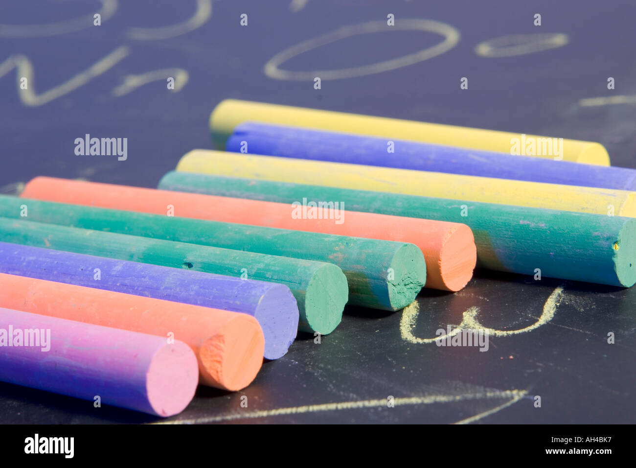 Color chalk on chalkboard with alphabet Stock Photo - Alamy