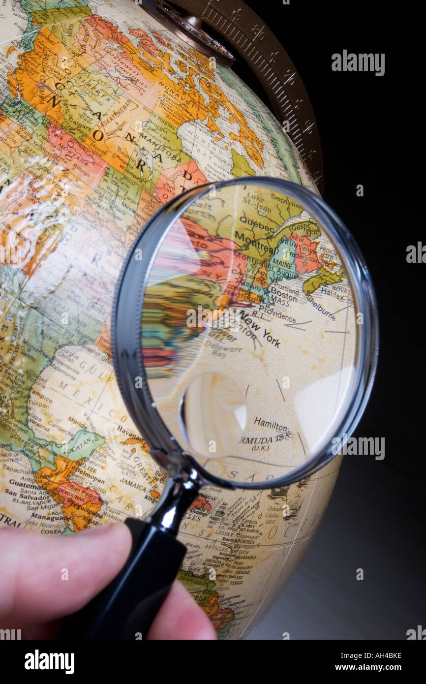 Globe and magnifying glass Stock Photo - Alamy