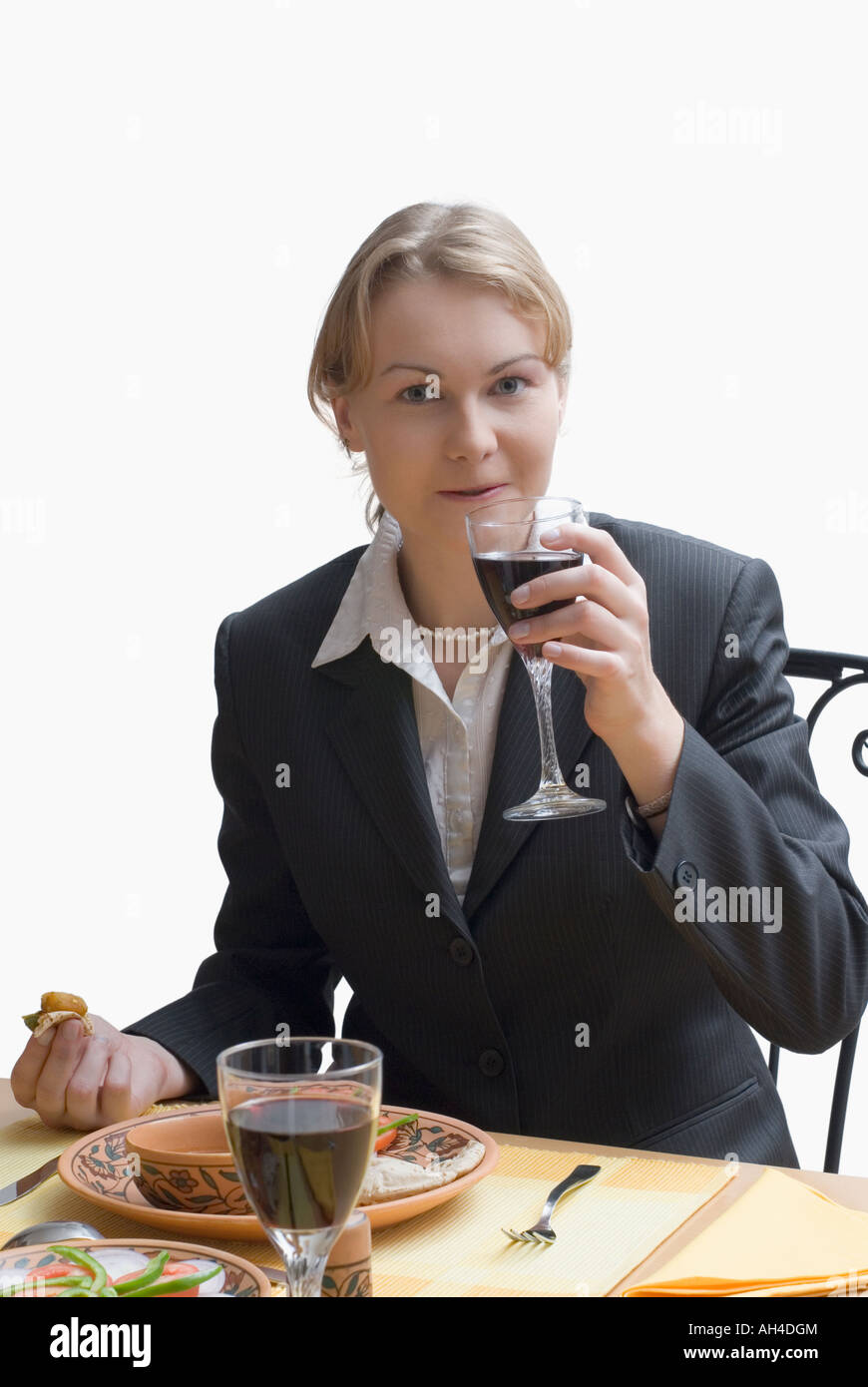 Portrait of a businesswoman drinking red wine at the dining table Stock ...