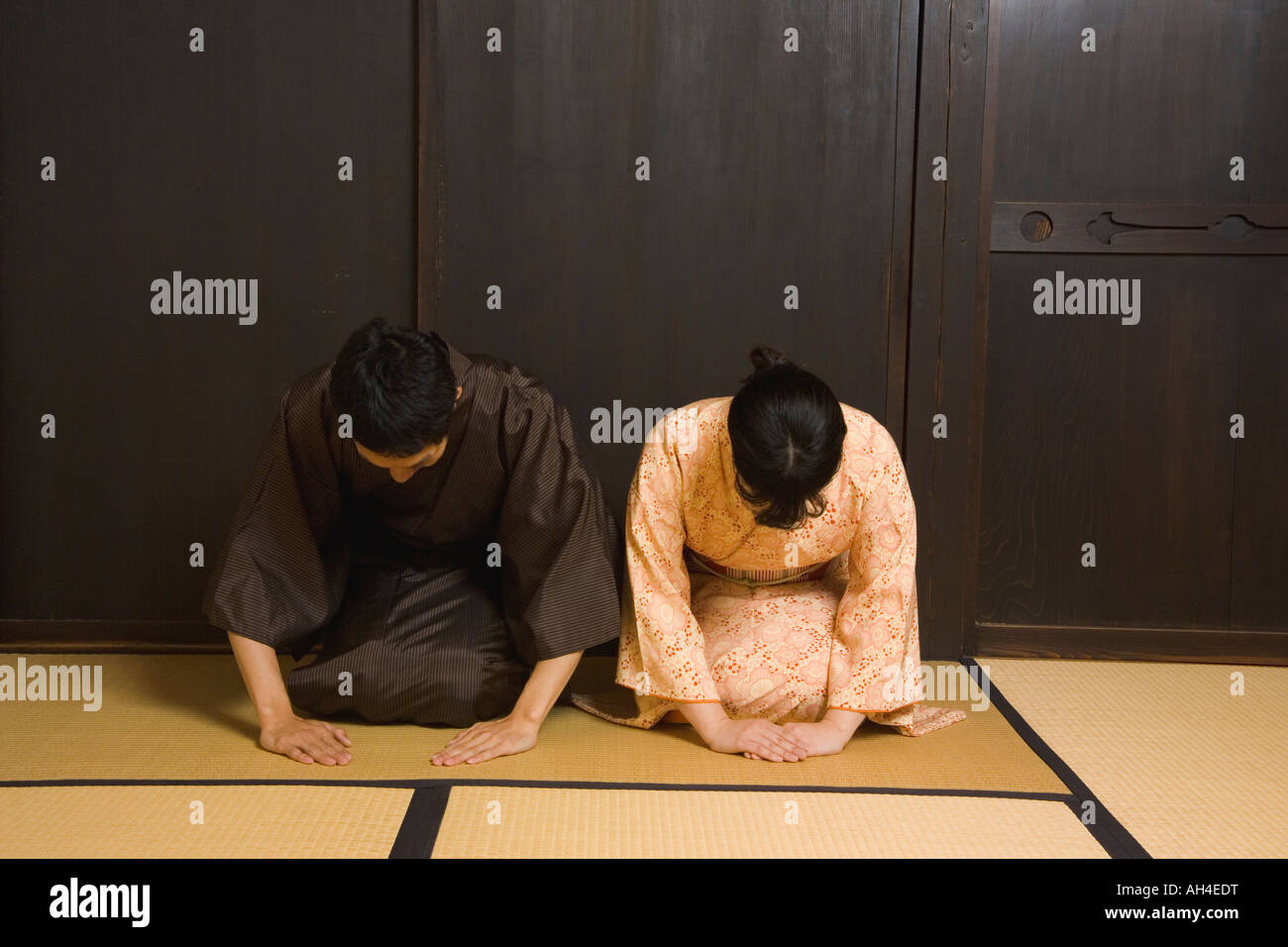 Man and woman bowing Stock Photo - Alamy