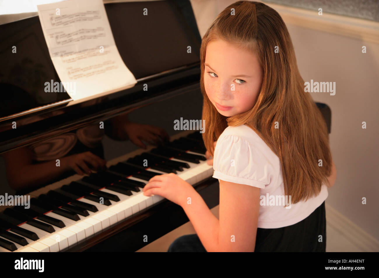 Girl practising piano Stock Photo - Alamy
