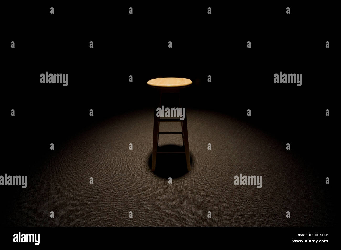 Stool in the spotlight Stock Photo - Alamy