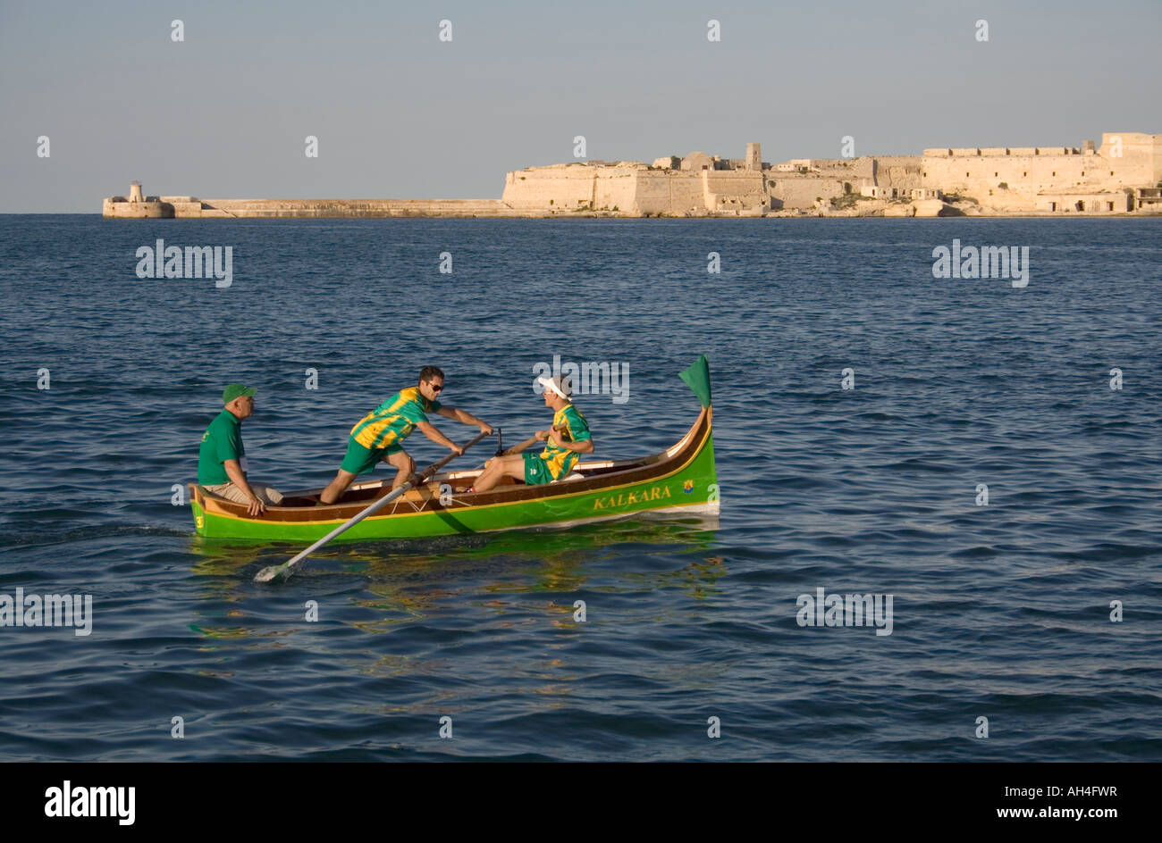Regatta rowers in the Grand Harbour, Malta, with Fort Ricasoli in the ...