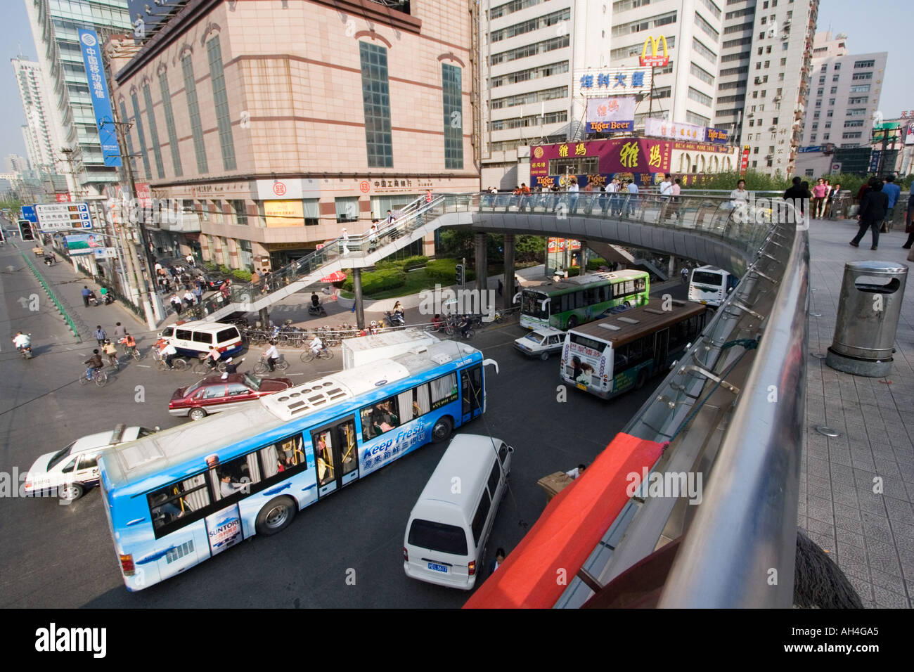 A pedestrian bridge crosses over a busy intersection in Shanghai China ...