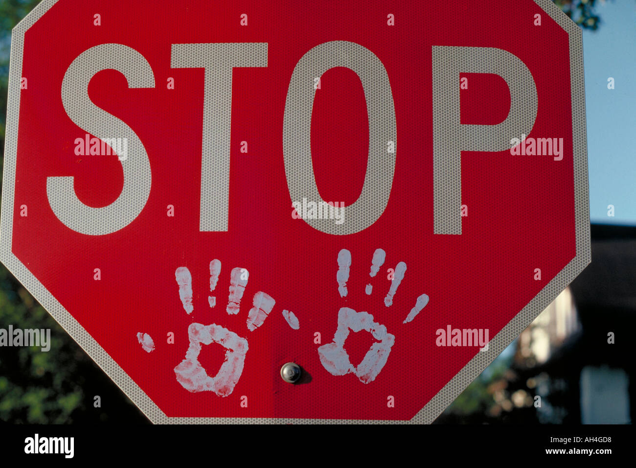 A stop sign with two white painted hand slaps Stock Photo - Alamy