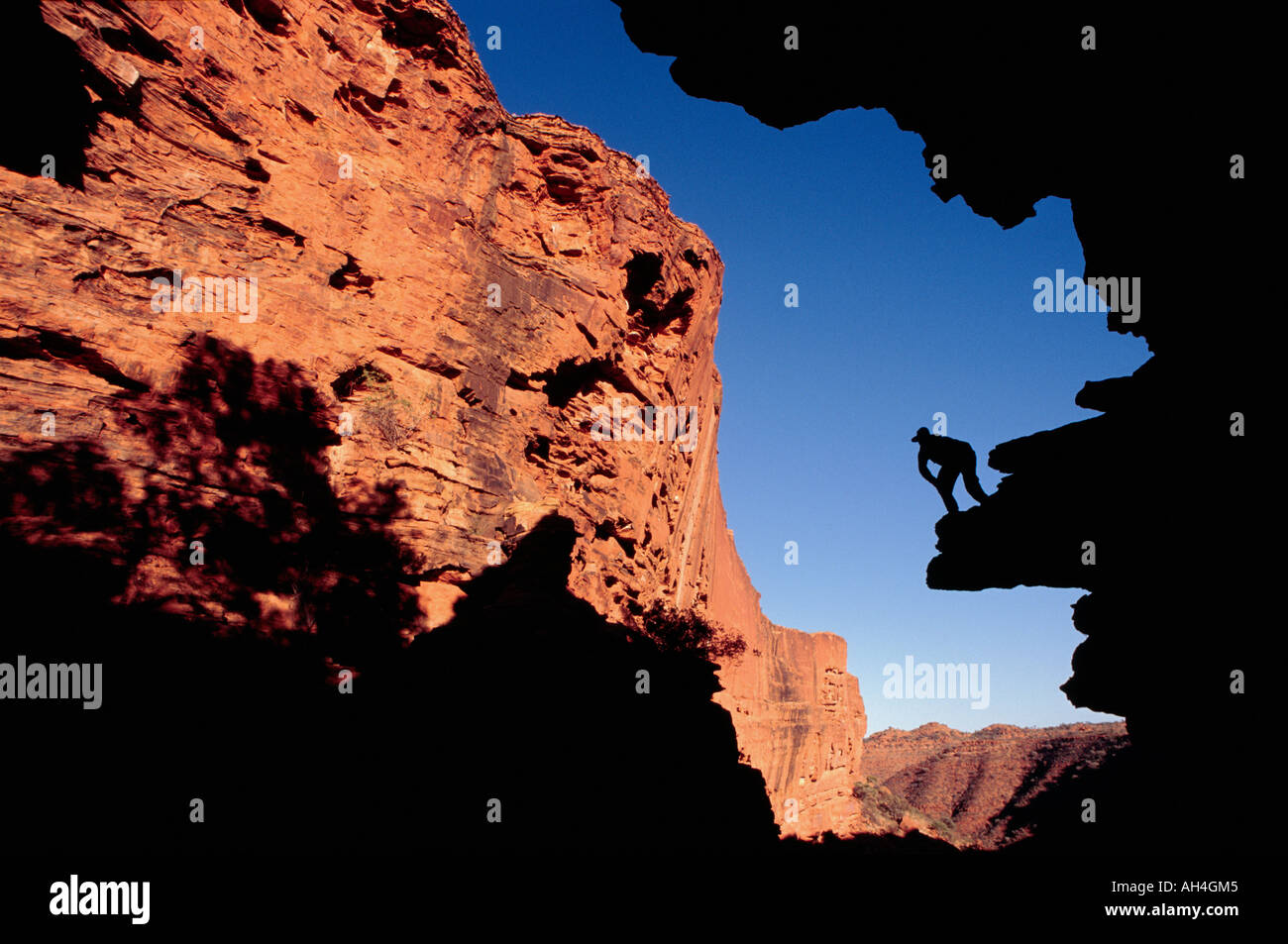 adventurer on a ledge in a rock face , King's Canyon, Northern ...